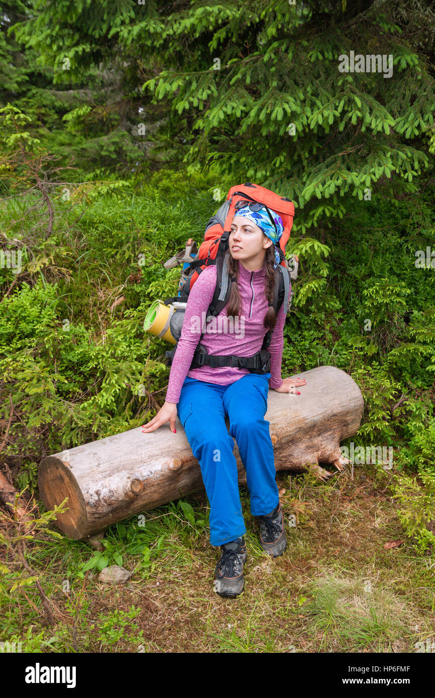 woman hiker rest in beautiful forest. Girl tourist resting of forest ...