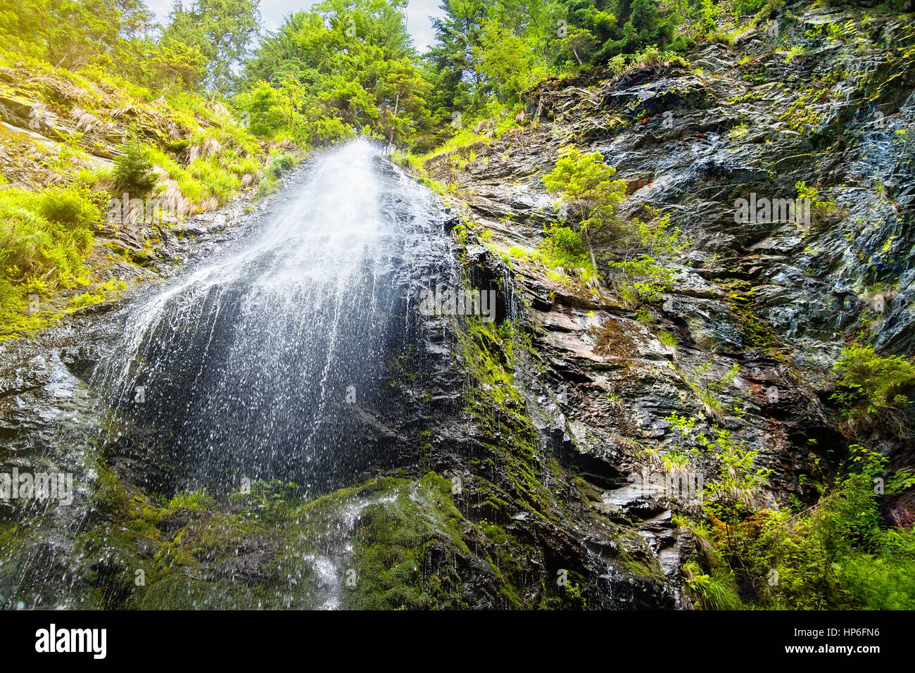 waterfall in mountain forest. Forest waterfall and rocks covered with ...