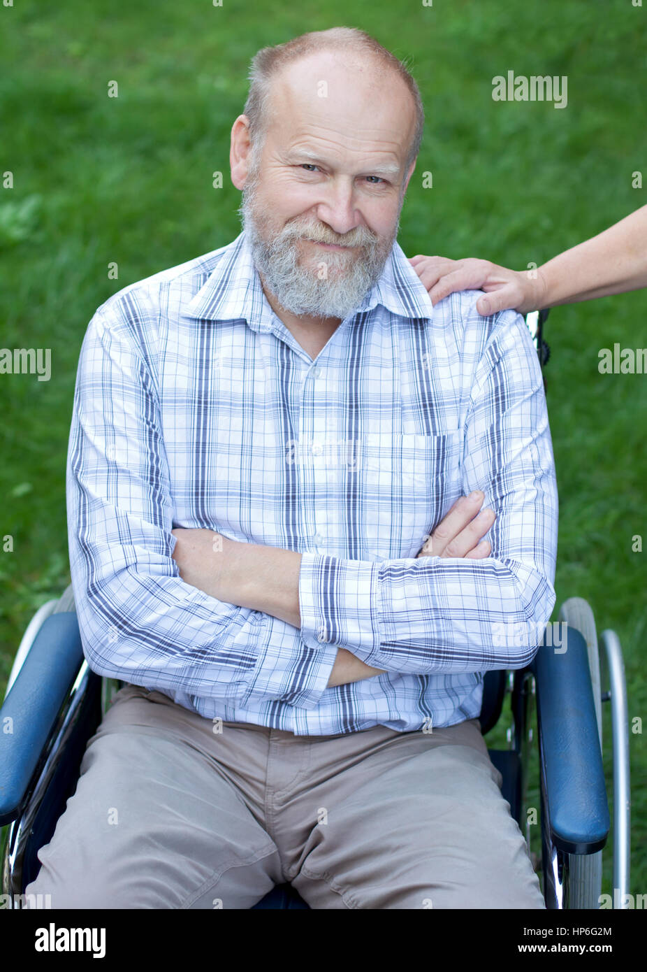 Handicapped elderly man sitting in a wheelchair Stock Photo - Alamy