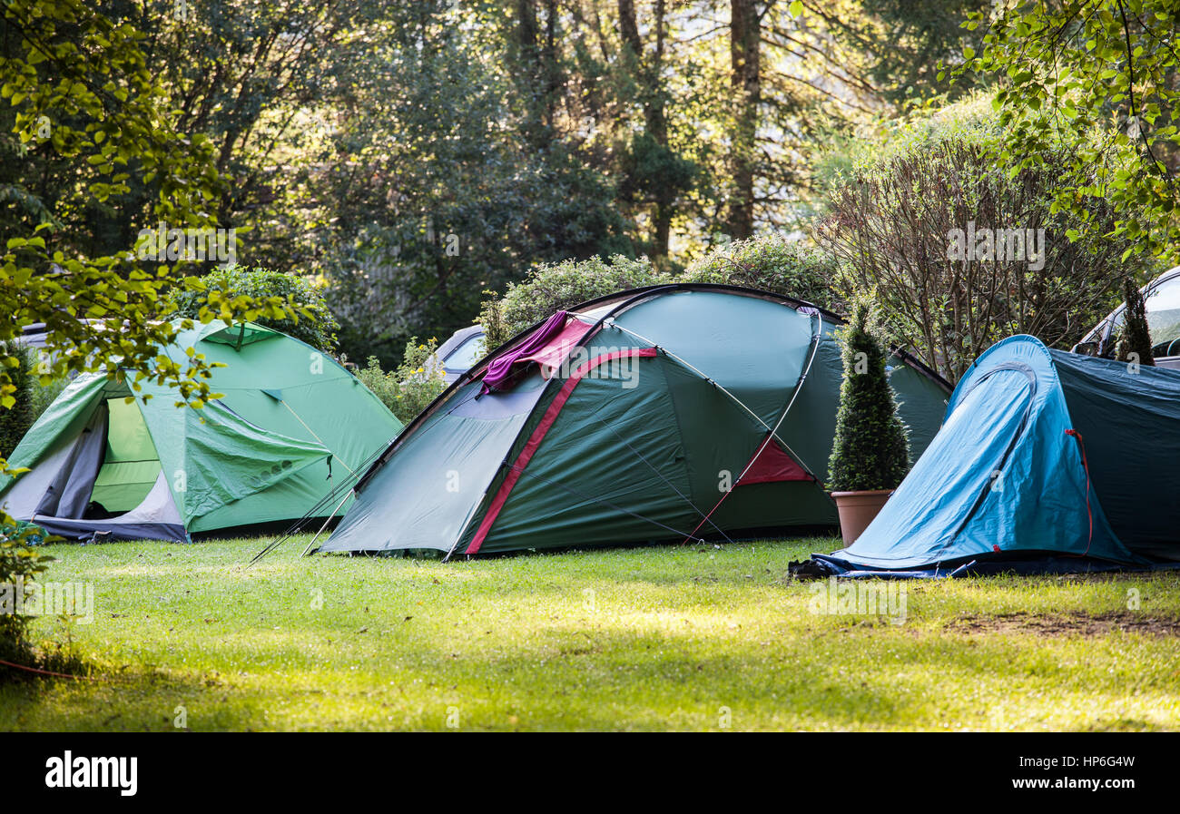 Camping area with tents on green grass lawn Stock Photo - Alamy