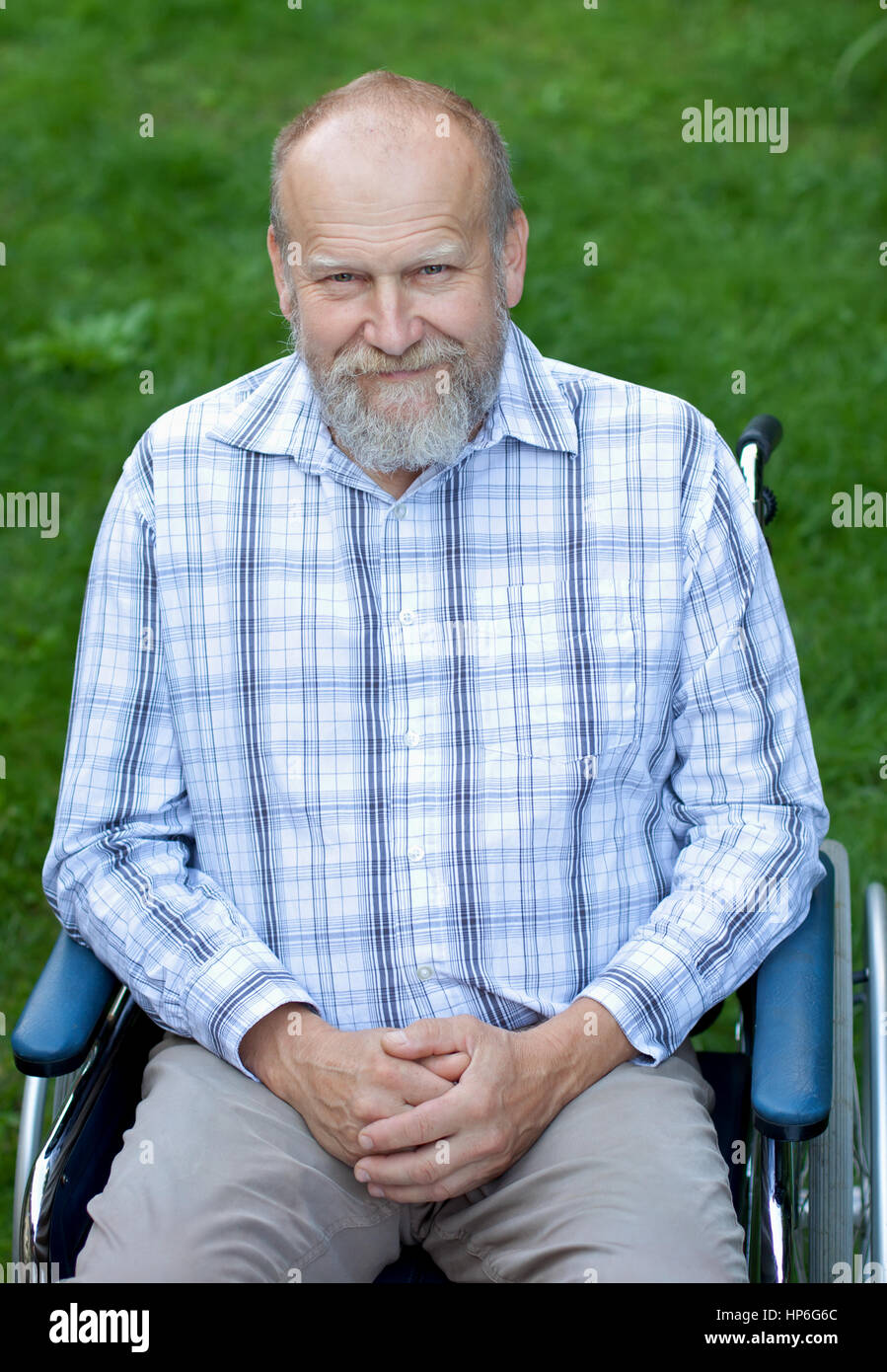 Handicapped elderly man sitting in a wheelchair Stock Photo - Alamy