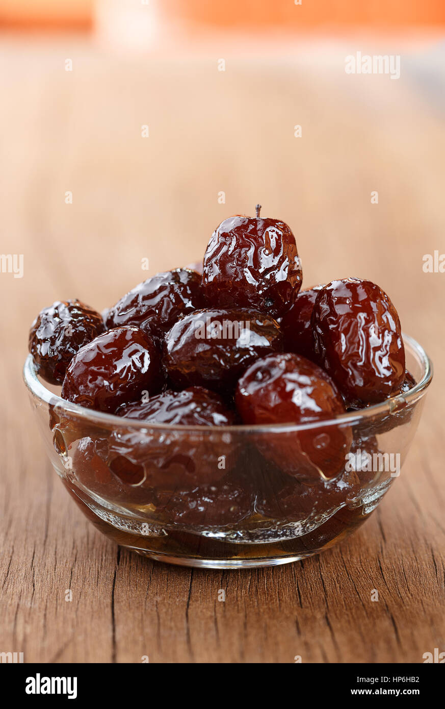 red date syrup product in bowl on wood front view Stock Photo - Alamy