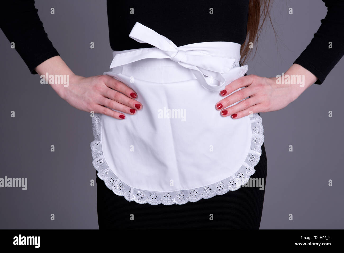 Waitress with painted nails with hands on her hips and apron Stock ...
