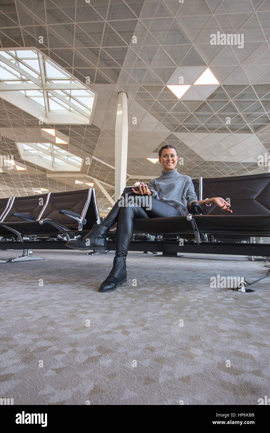 Pretty caucasian Woman Sitting In Airport Lounge Stock Photo - Alamy