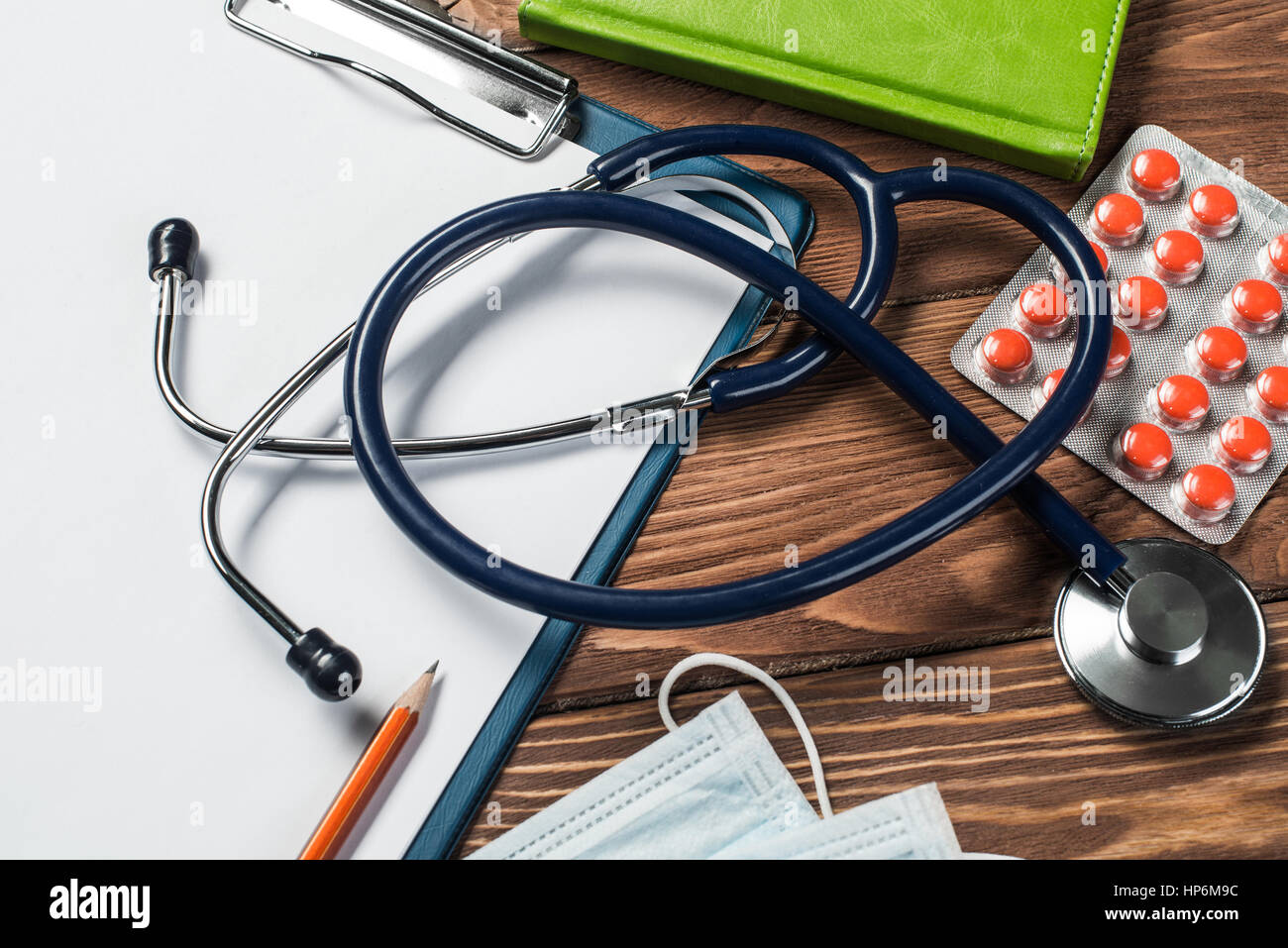 Doctors wooden table with tablet stethoscope and other stuff Stock ...