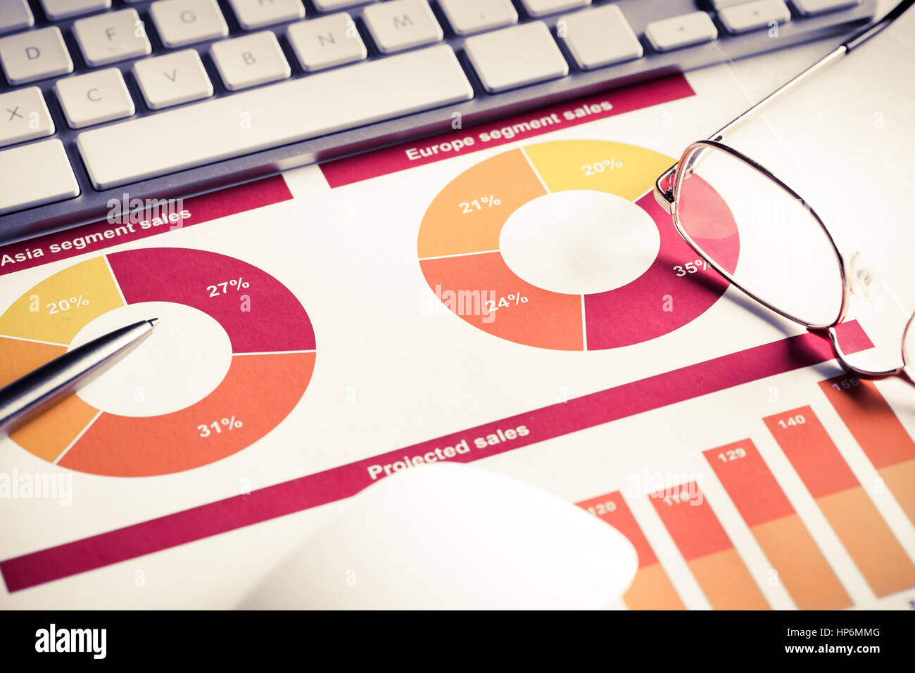 Business workplace with keyboard mouse and papers with graphs and ...