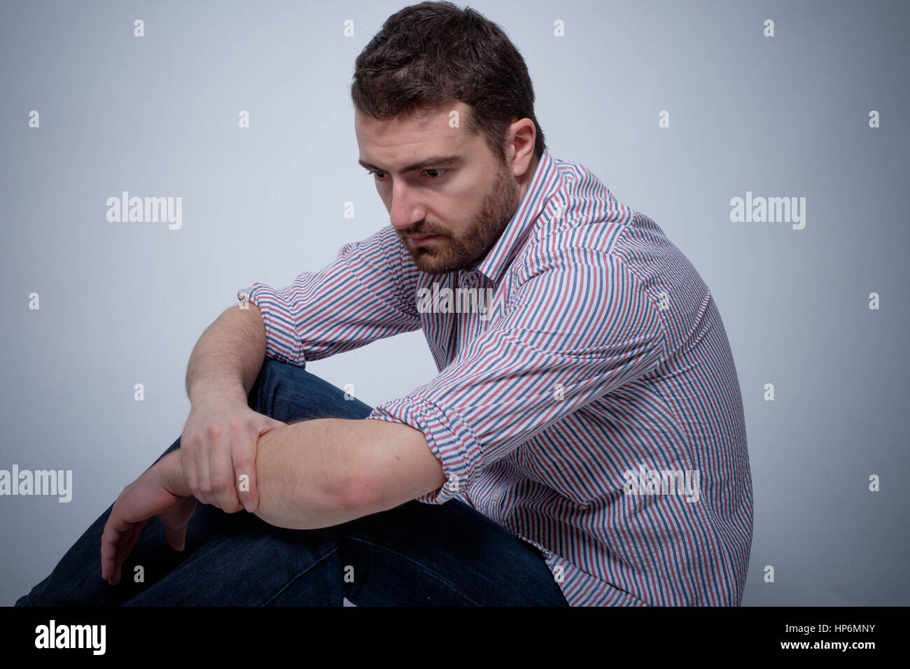 Man depressed with upset face expression Stock Photo - Alamy