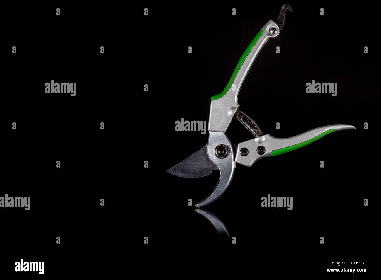 an open pruning shears with green handles Stock Photo - Alamy