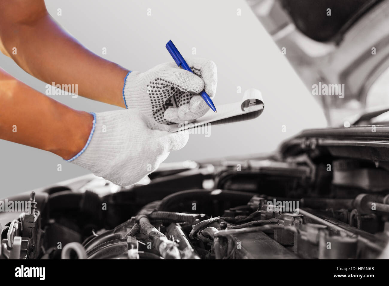 Auto mechanic checking car engine at the garage Stock Photo - Alamy