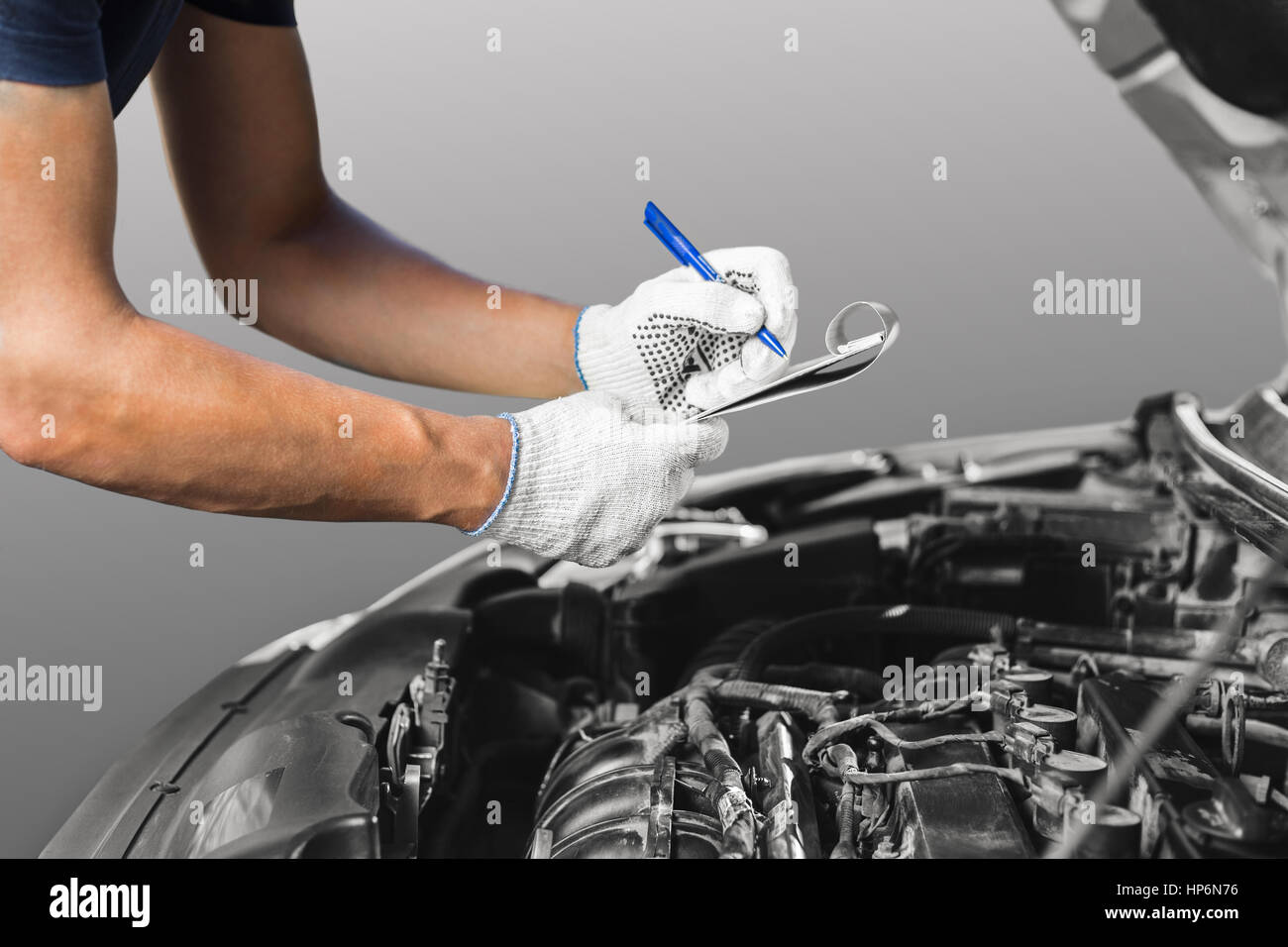 Auto mechanic checking car engine at the garage Stock Photo - Alamy