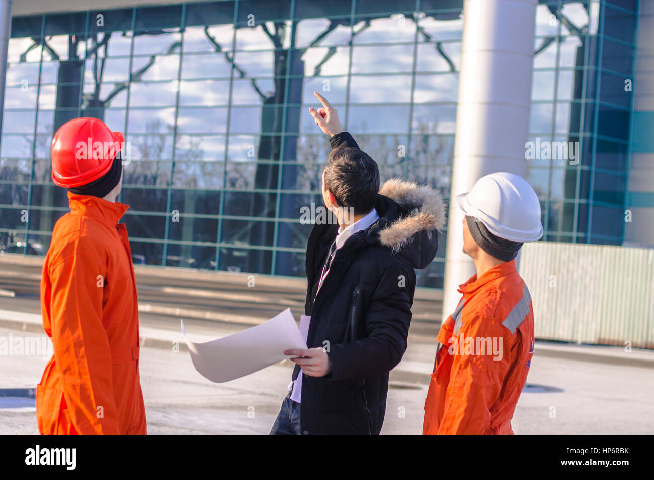 boss or Chief shows a construction project. Team of young engineers ...
