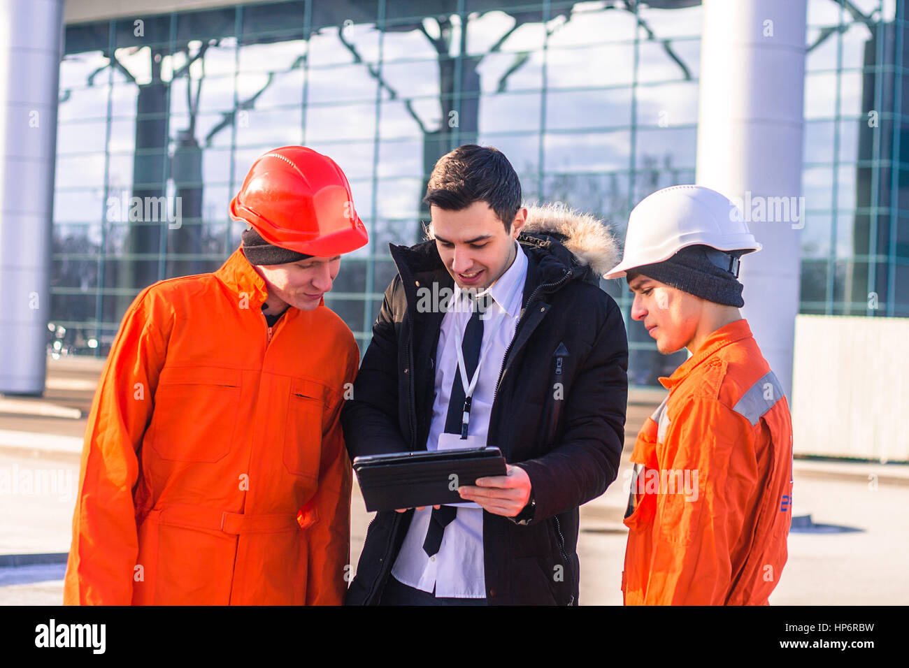 boss or Chief instructs young team of young engineers with a ...