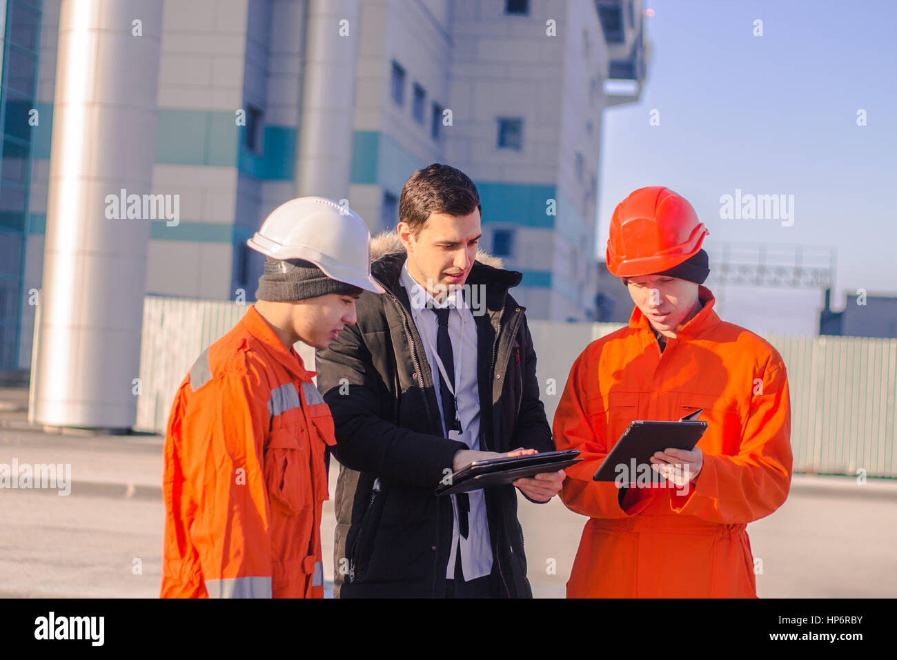 boss or Chief instructs young team of young engineers with a ...