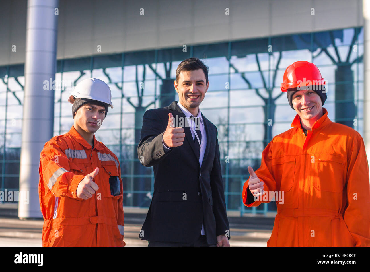 boss and team of young engineers showing thumbs up. Business modern ...