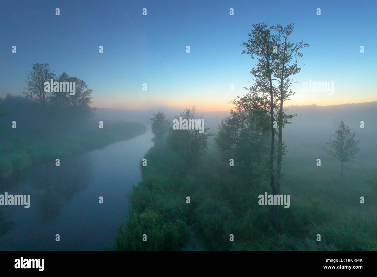 Landscape of misty morning on river. Foggy spring dawn. Green meadow in ...