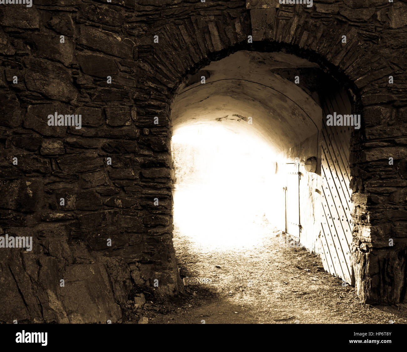 Old castle gate in Bergen Norway with strong sun light on the other ...