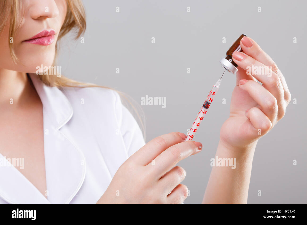 Nurse holding syringe Stock Photo - Alamy