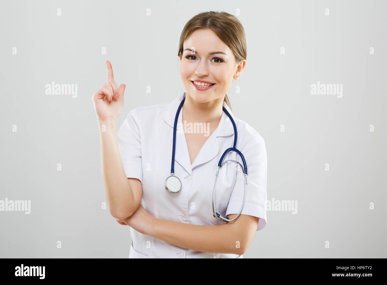 Pretty nurse at studio background Stock Photo - Alamy