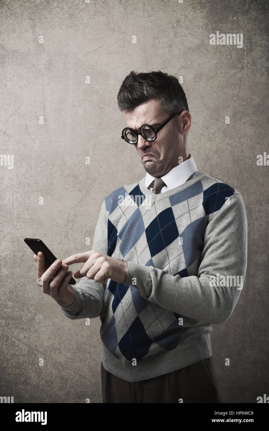 Funny clueless dumb guy having troubles with his smartphone Stock Photo ...
