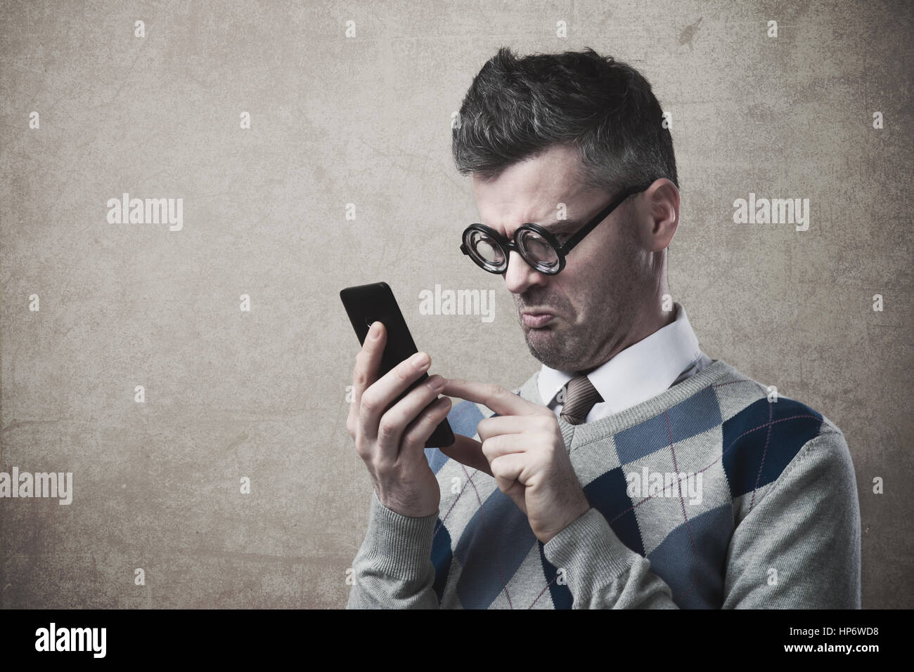 Funny clueless dumb guy having troubles with his smartphone Stock Photo ...