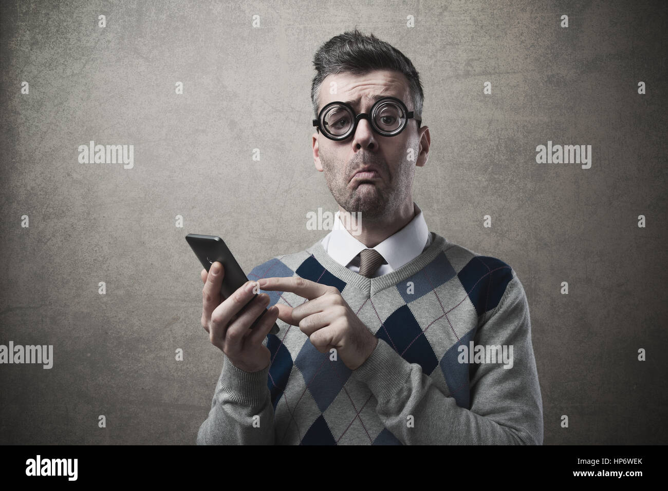 Funny clueless dumb guy having troubles with his smartphone Stock Photo ...