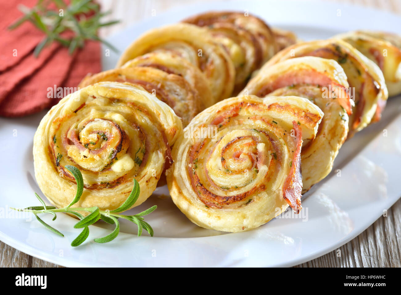 Baked hearty puff pastry rolls with ham, cream cheese, parmesan and ...