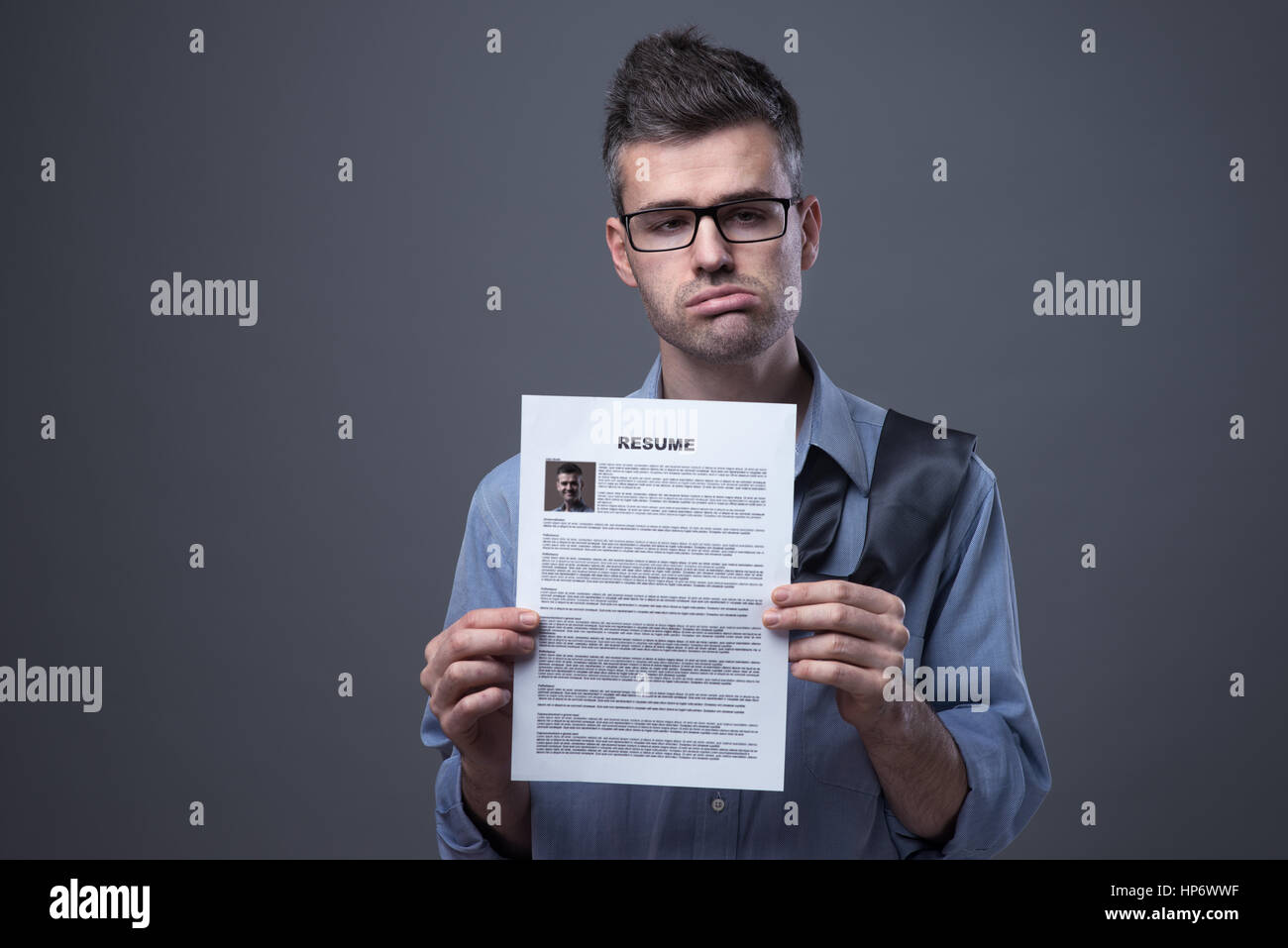 Sad businessman looking for a job and holding his resume Stock Photo ...