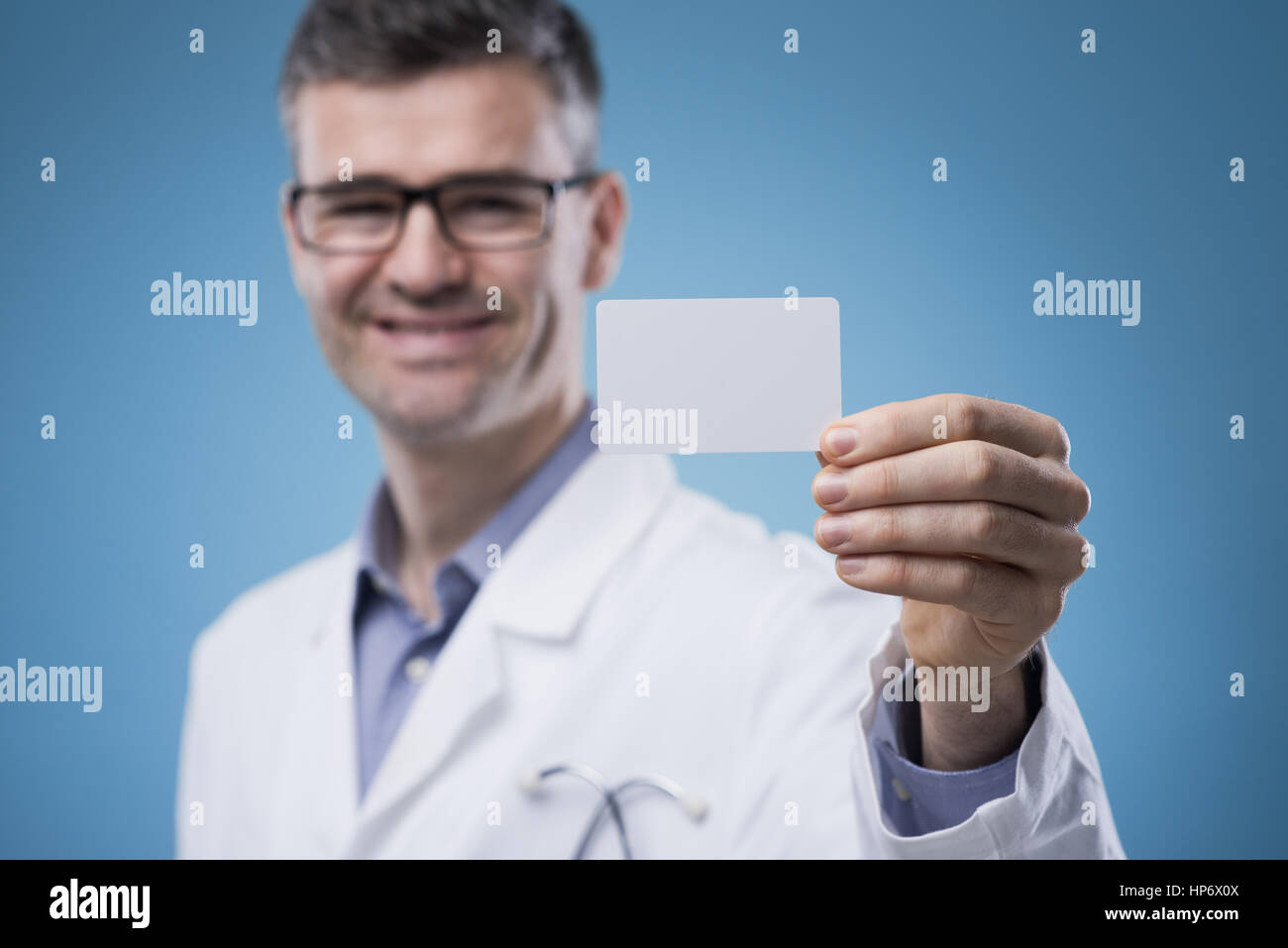 Smiling doctor holding a blank business card Stock Photo - Alamy Smiling doctor holding a blank business card Stock Photo - Alamy