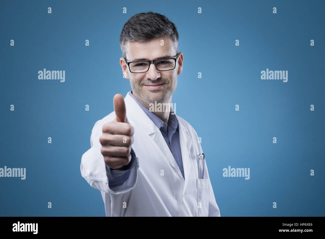 Cheerful smiling doctor thumbs up looking at camera Stock Photo - Alamy