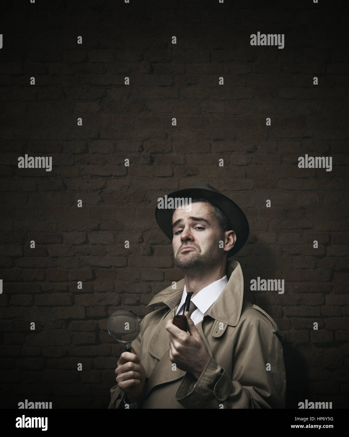 Funny vintage investigator in trench coat holding a pipe Stock Photo ...