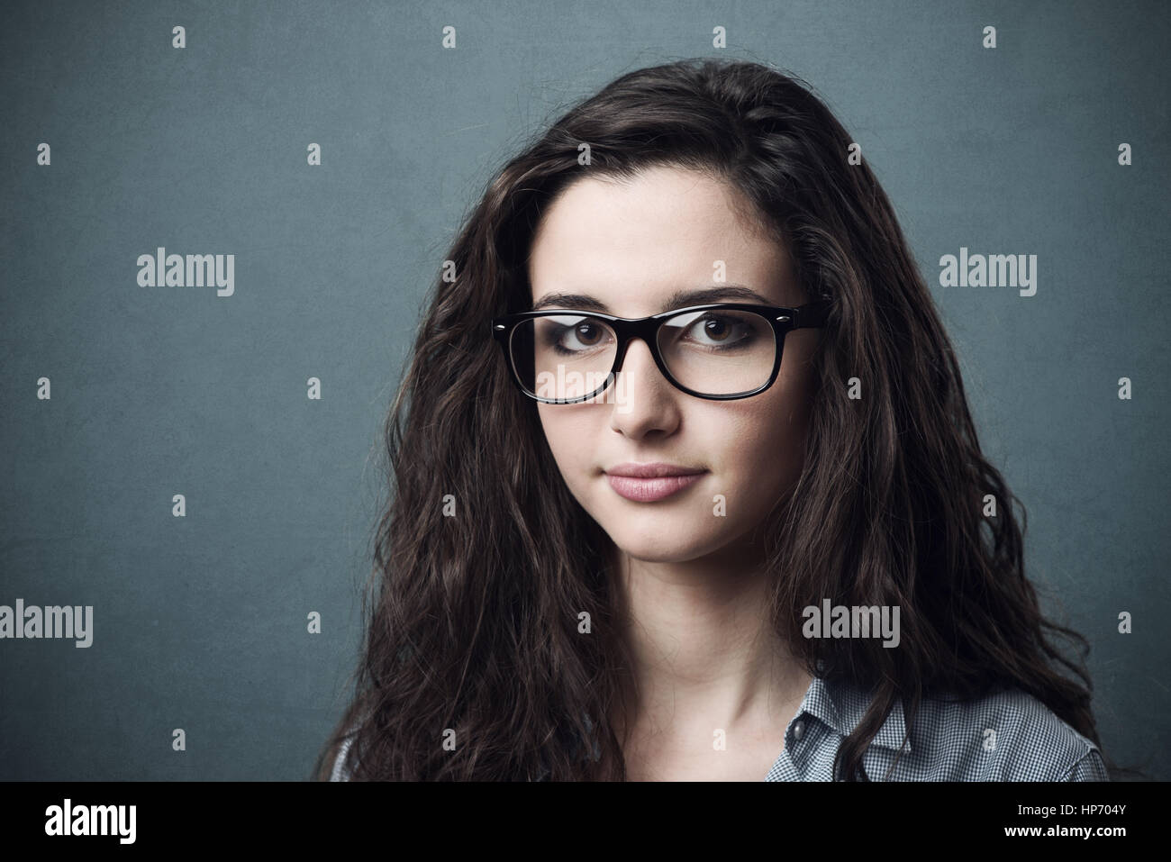 Young nerd woman with black glasses smiling at camera Stock Photo - Alamy