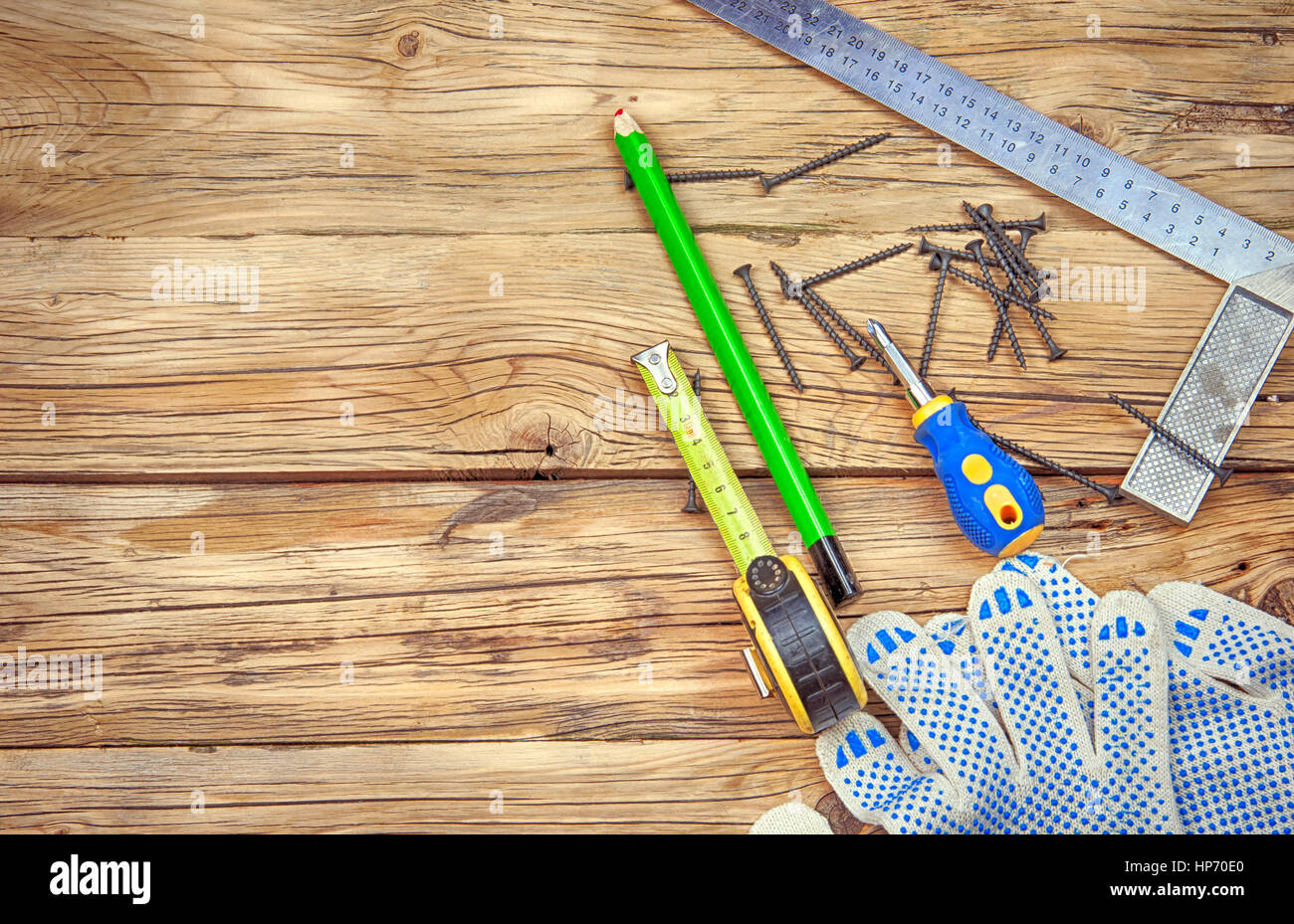 gloves and tools on wooden table Stock Photo - Alamy