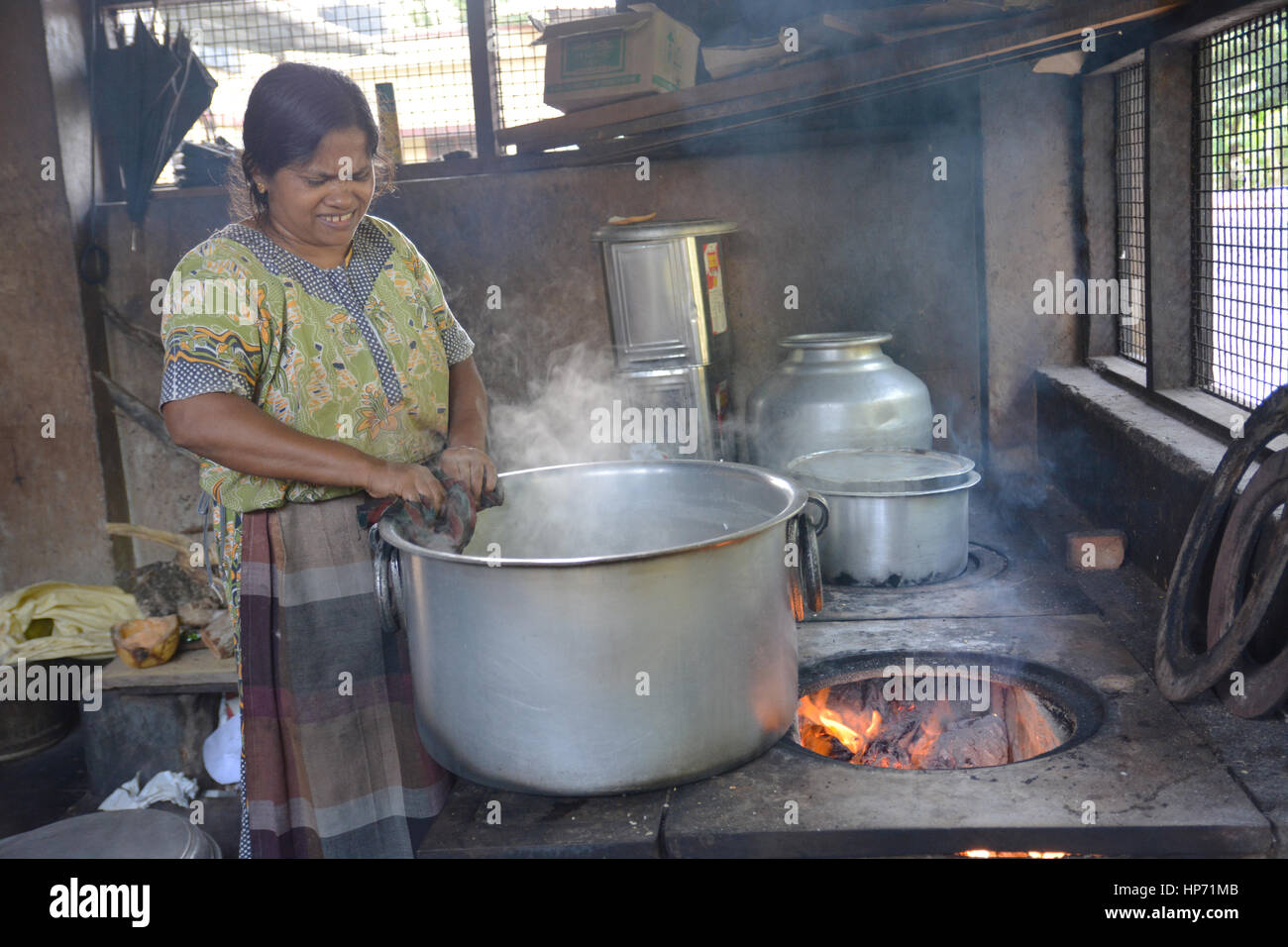 Mumbai, India - October 28, 2015 - Woman cooking rice in a traditional ...