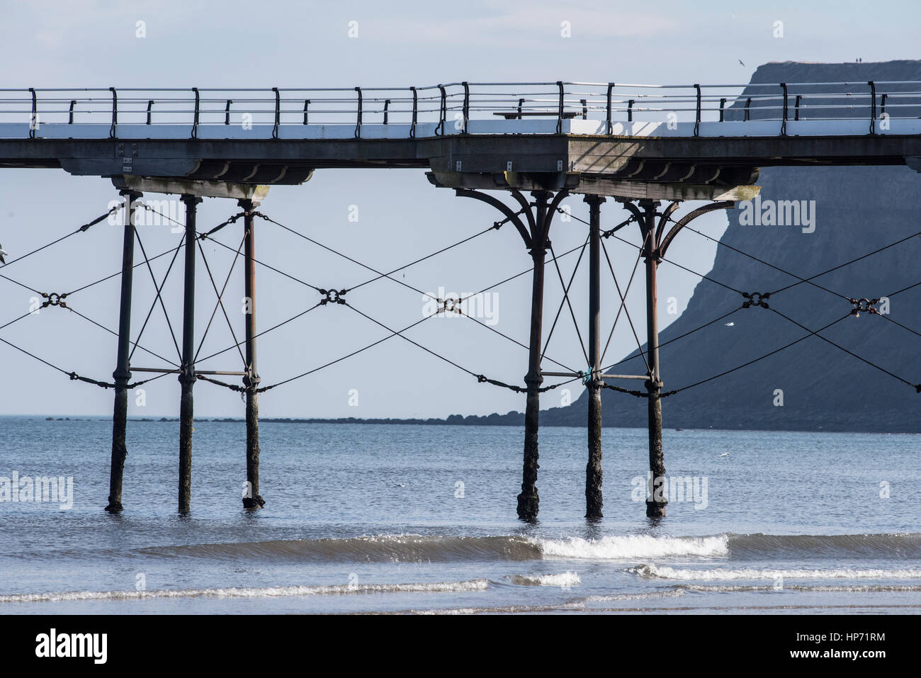 Saltburn Pier, showing legs and bracing wire, with cliff behind ...