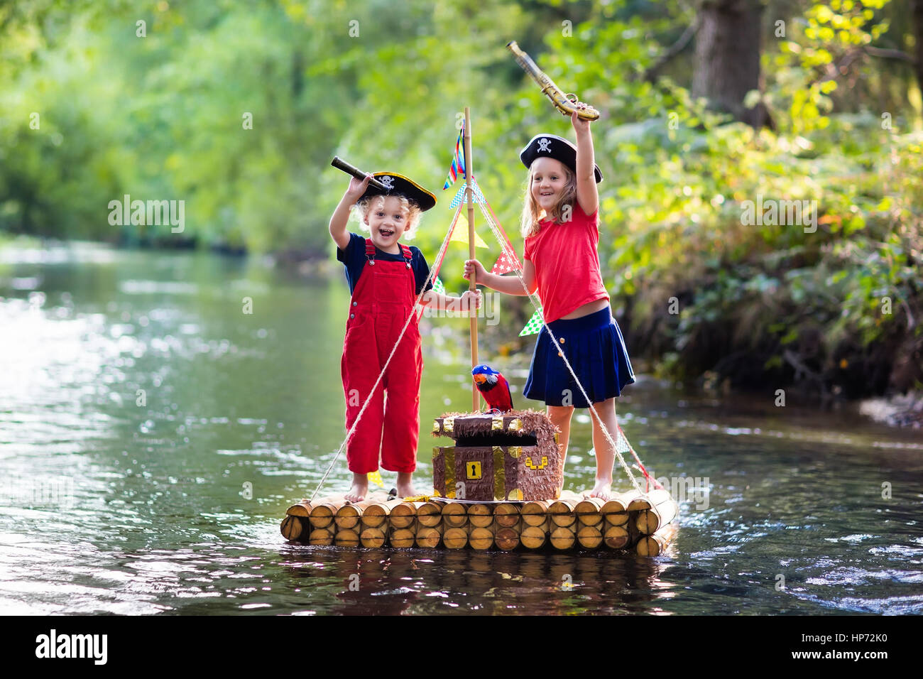 Kids dressed in pirate costumes and hats with treasure chest ...