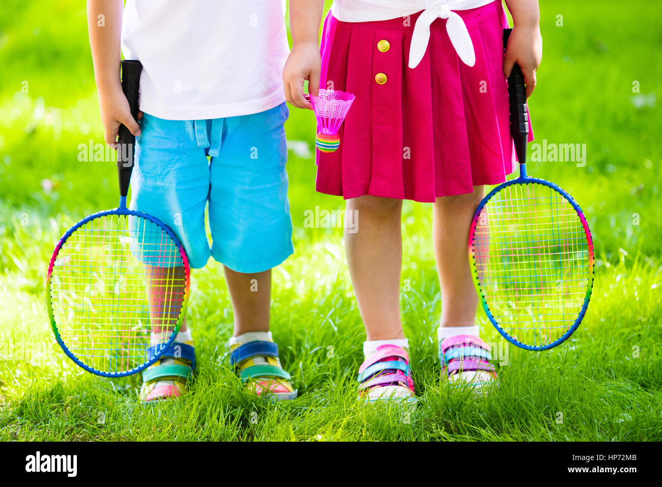 Active preschool girl and boy playing badminton in outdoor court in ...