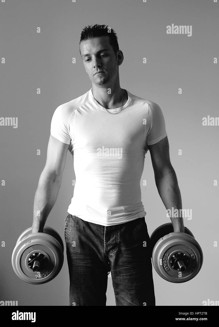 Man training home weights Black and White Stock Photos & Images - Alamy