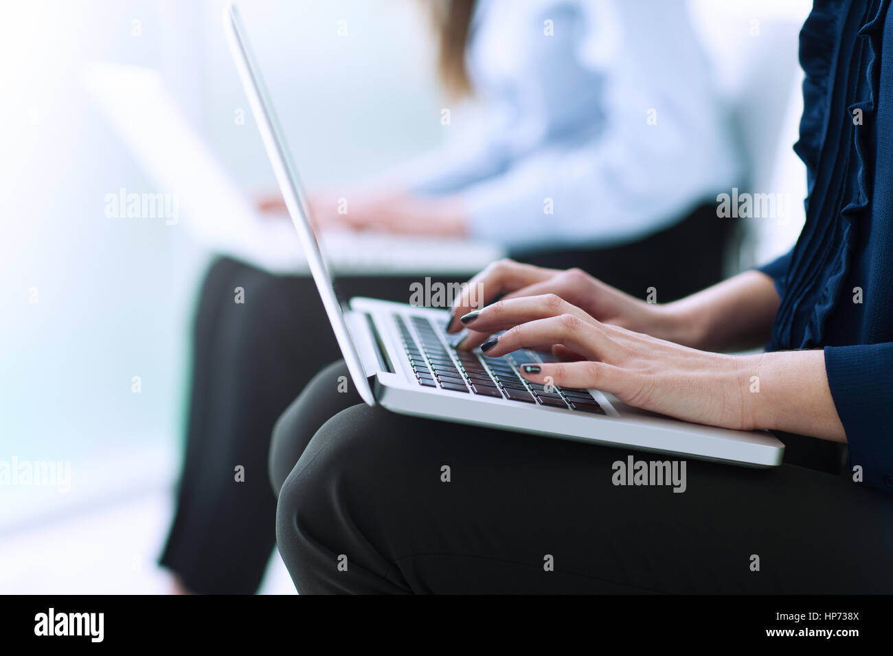 Wireless internet access hotspot, women using laptop, typing and ...