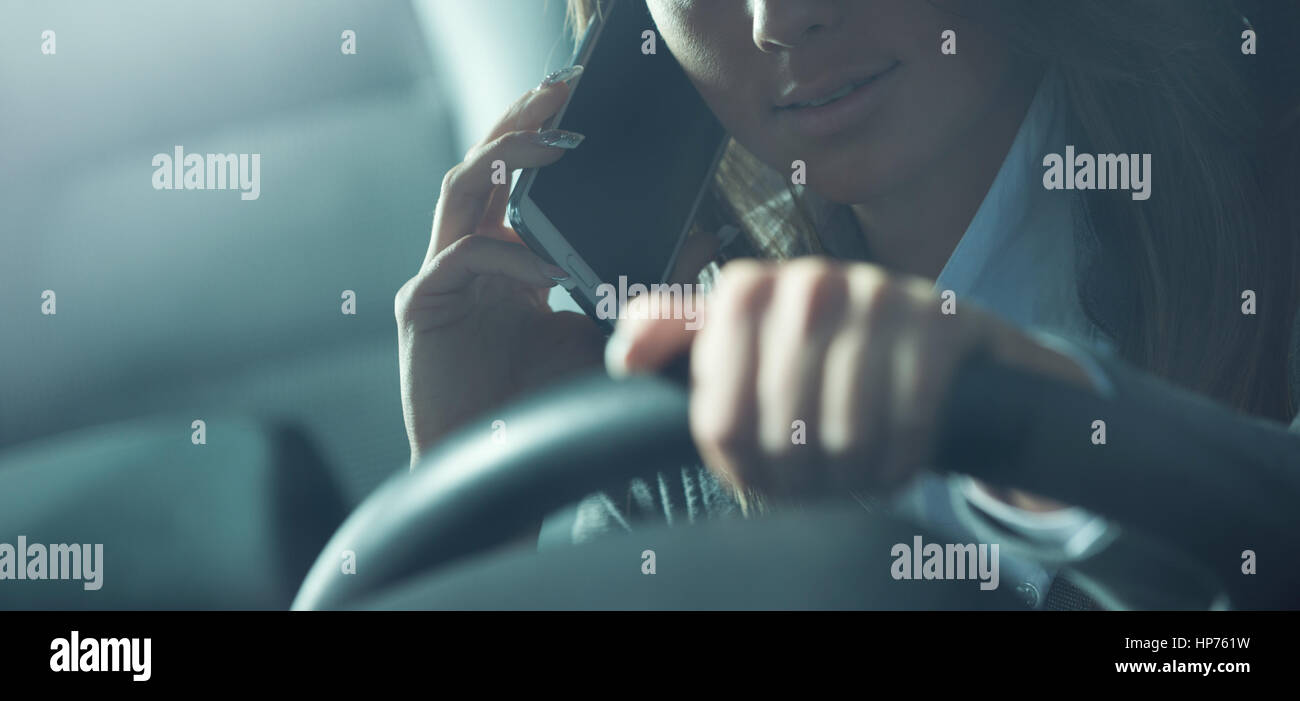 Young woman calling on the phone while driving late at night Stock ...