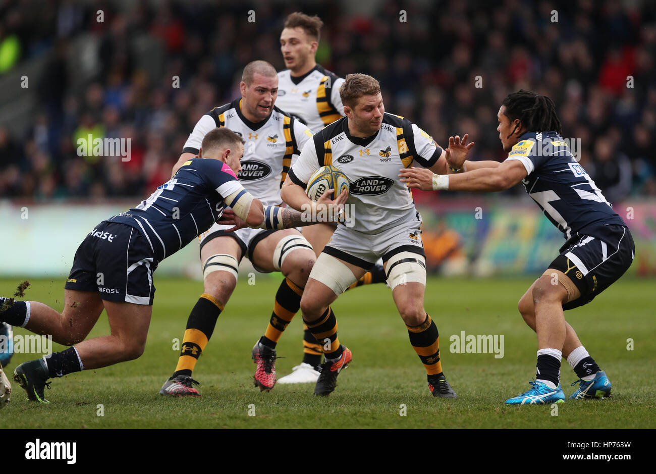 Wasps' Thomas Young hands off Sale's TJ Ioane during the Aviva ...