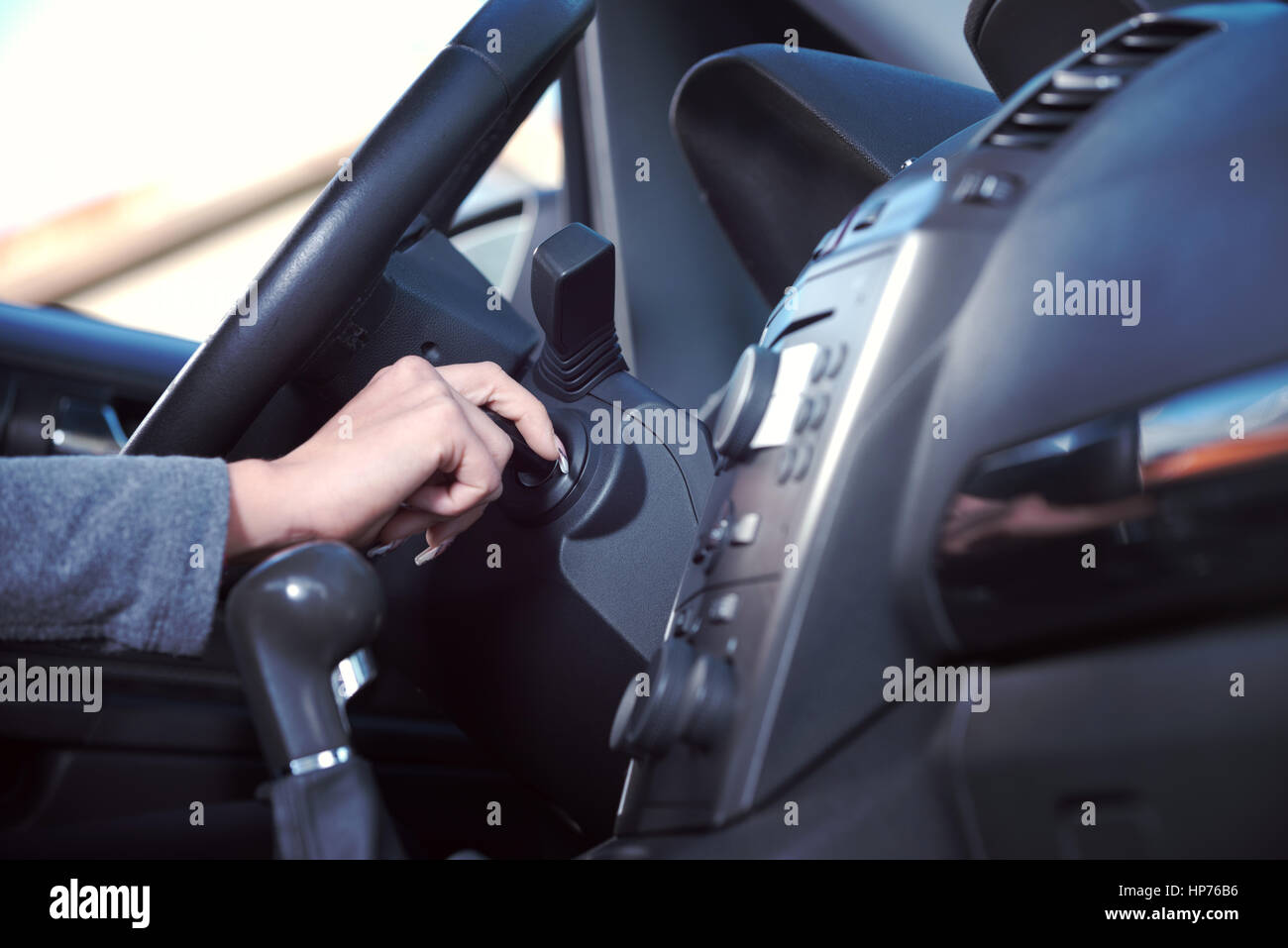 Female driver hand inserting car key and starting engine Stock Photo ...