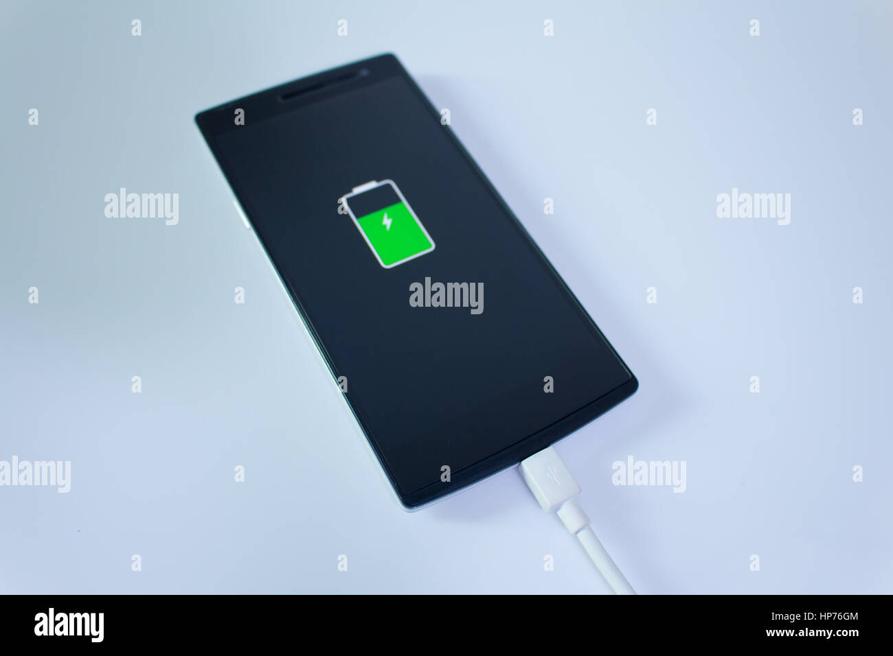 Mobile smart phone is charging with graphic on it screen Stock Photo ...