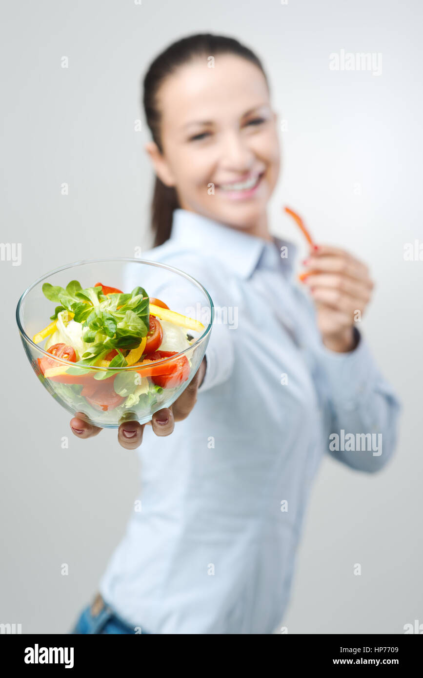 Cheerful woman eating salad and smiling, healthy eating concept Stock ...