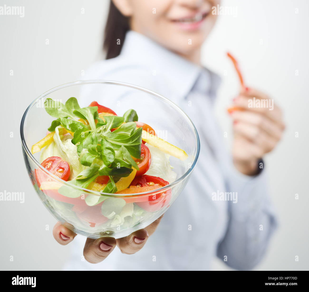 Cheerful woman eating salad and smiling, healthy eating concept Stock ...