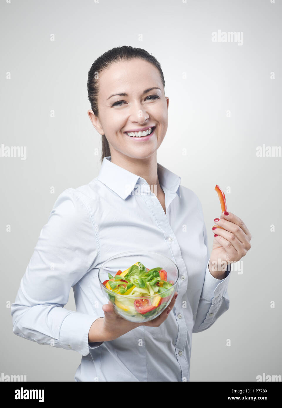 Cheerful woman eating salad and smiling, healthy eating concept Stock ...