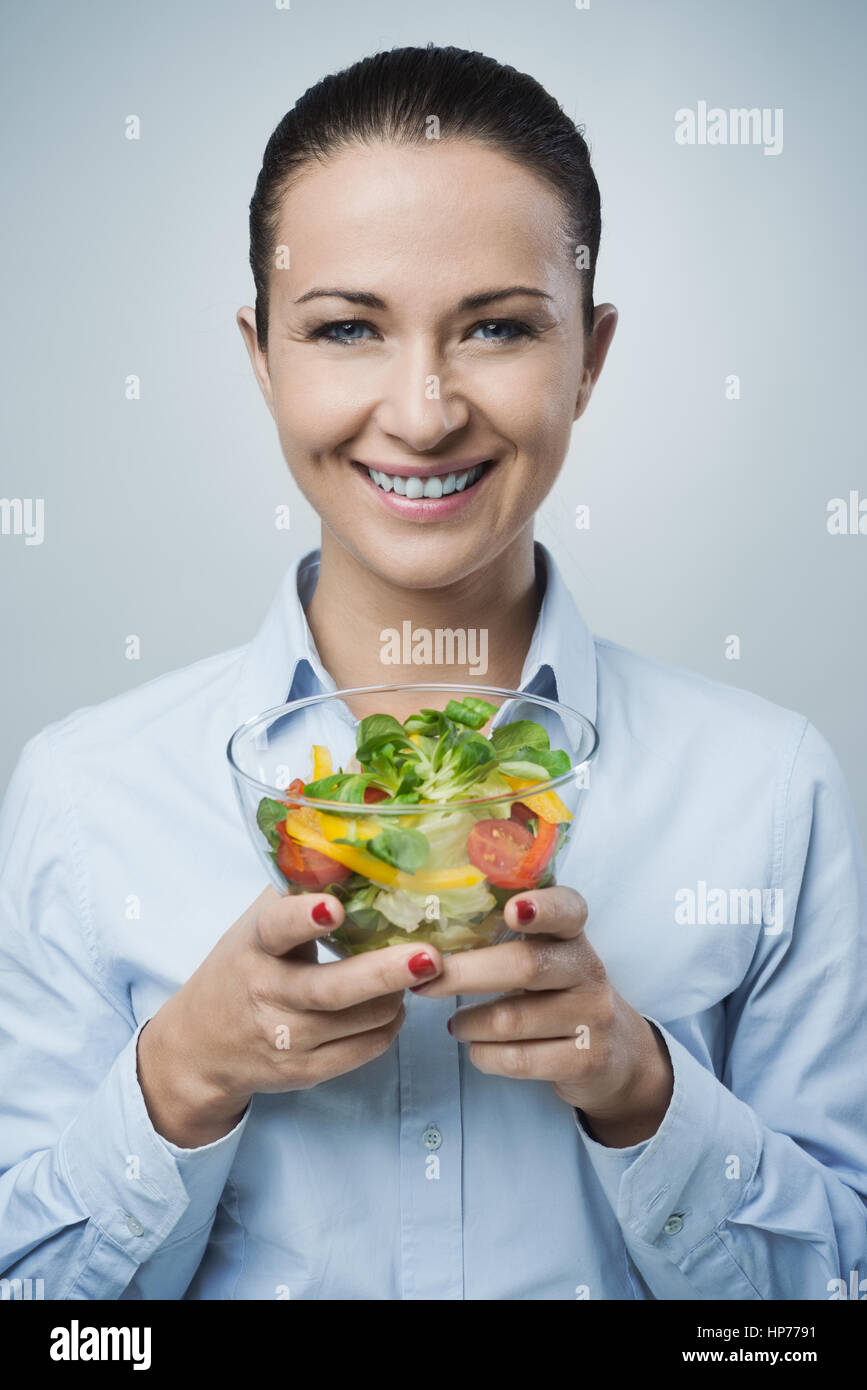 Cheerful woman eating salad and smiling, healthy eating concept Stock ...
