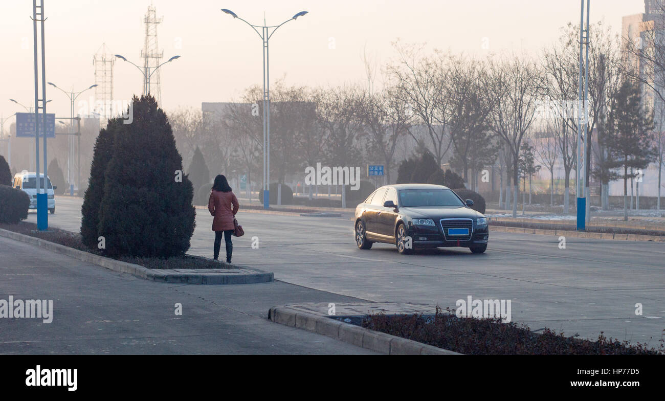 Young woman waiting for lift, Dawukou, Ningxia, China Stock Photo - Alamy