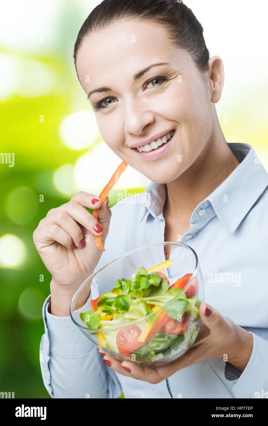 Cheerful woman eating salad and smiling, healthy eating concept Stock ...