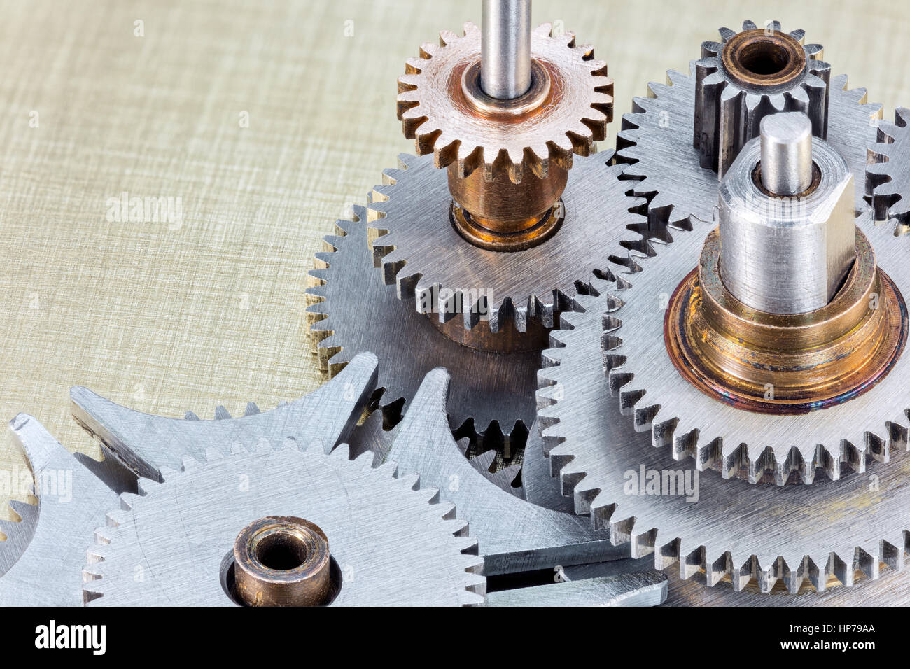 various metal cogwheels on industrial scratched background macro view ...