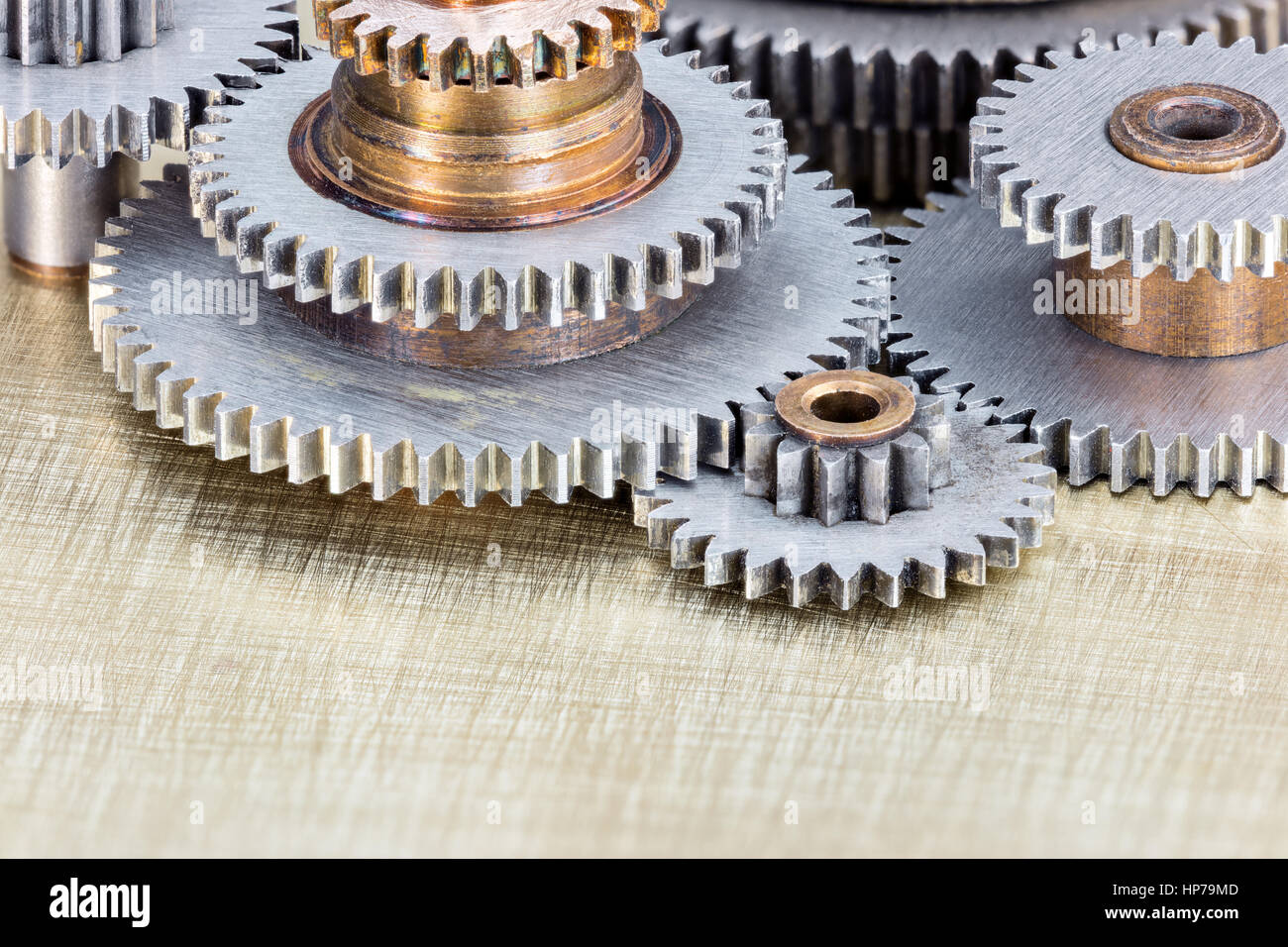 various cogwheels for industrial machines macro view on scratched brass ...